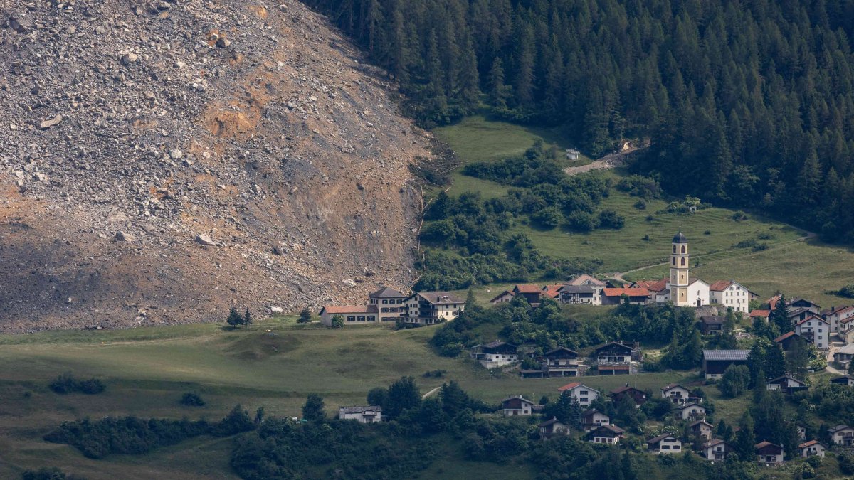 Mass of rock slides down mountainside above evacuated Swiss village ...